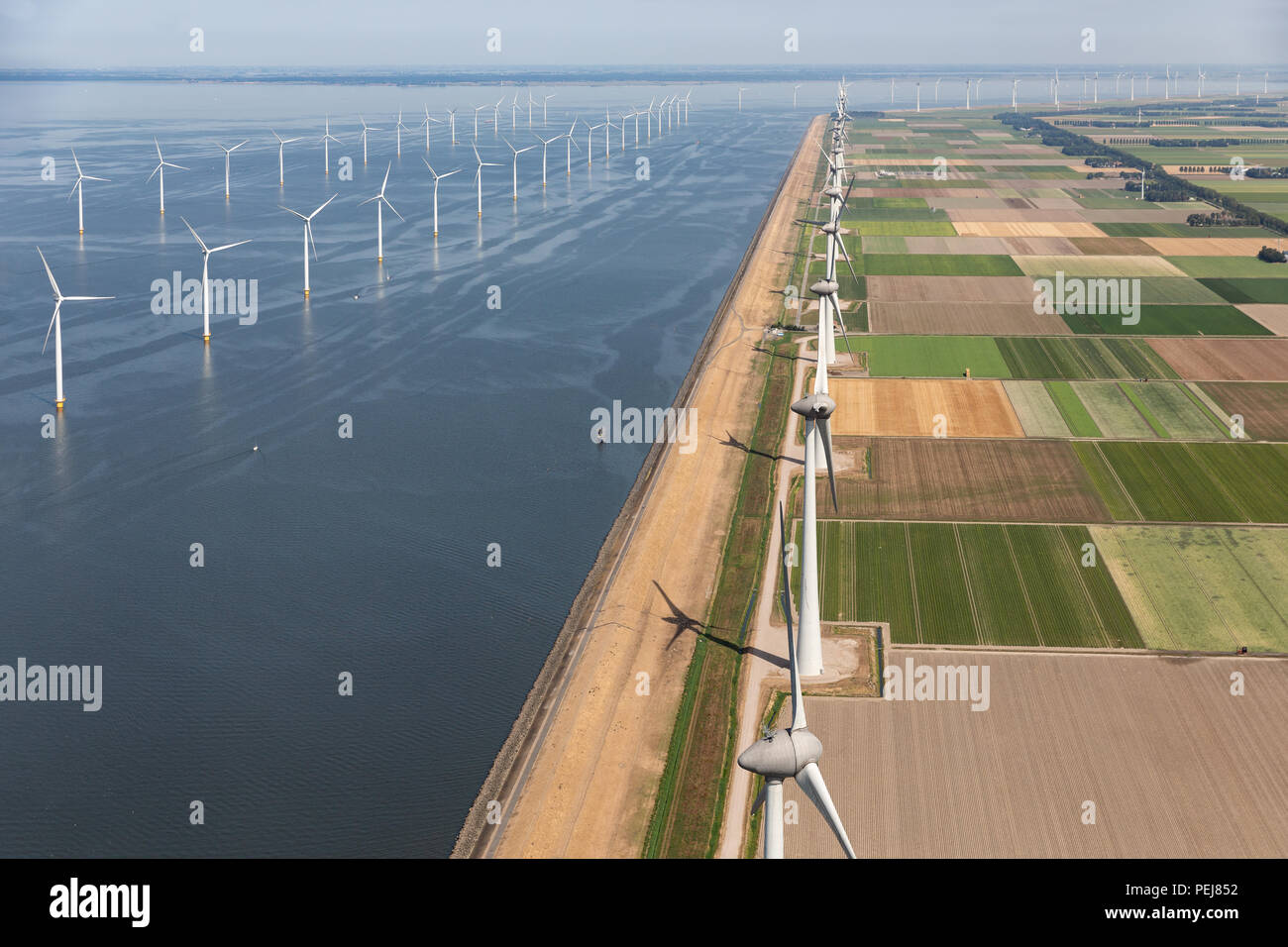 Aerial view Dutch landscape with offshore wind turbines along coast ...