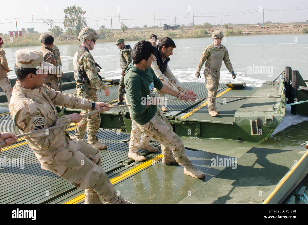Iraqi engineers with the 15th Iraqi Army Division, pull an interior bay ...