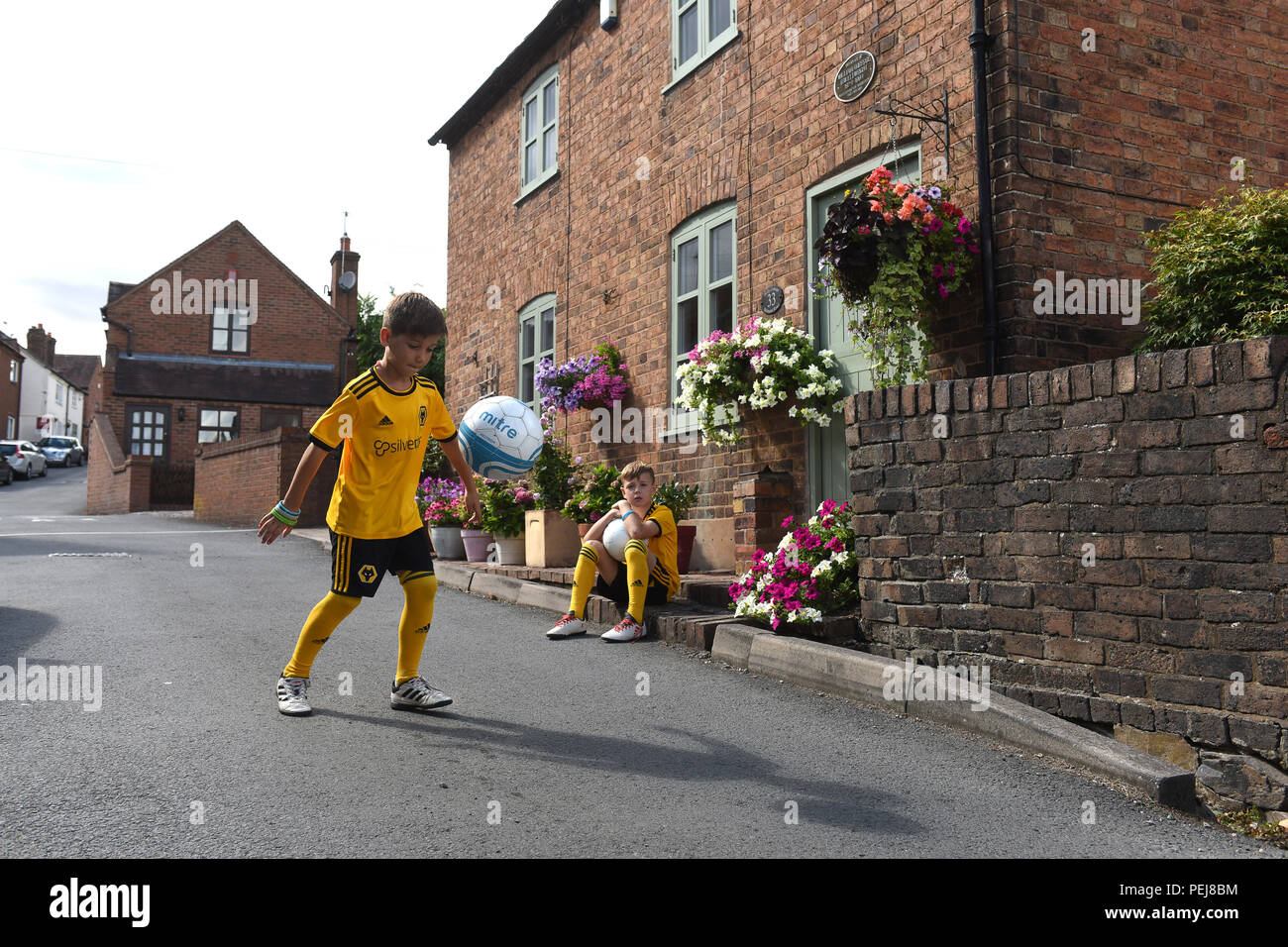 Boys in Wolverhampton Wanderers FC replica kits playing football ...