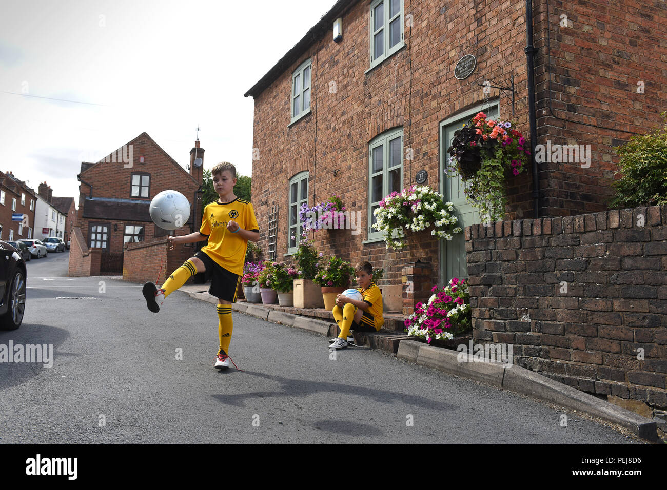 Boys in Wolverhampton Wanderers FC replica kits playing football ...