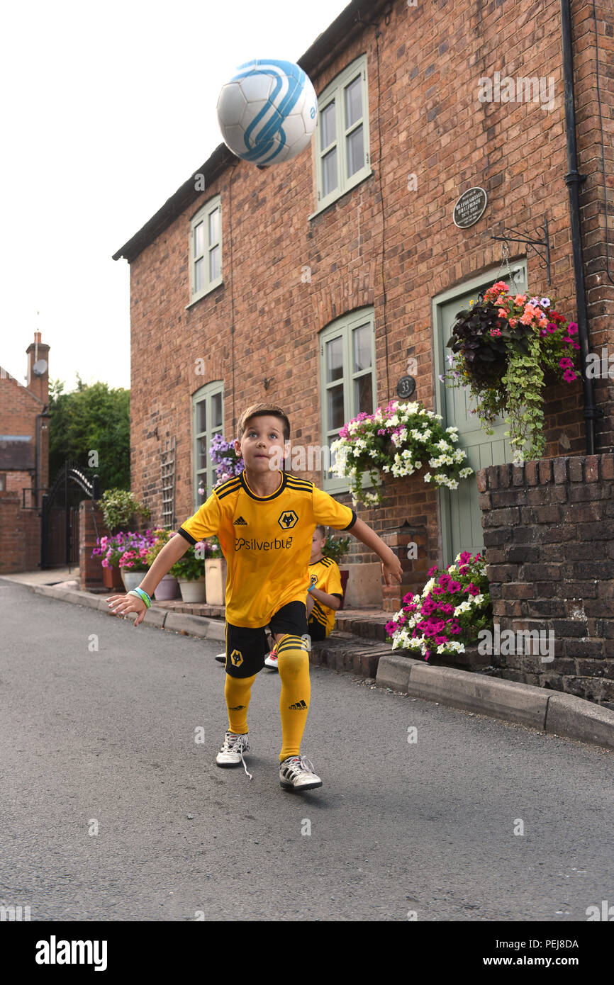 Boys in Wolverhampton Wanderers FC replica kits playing football ...