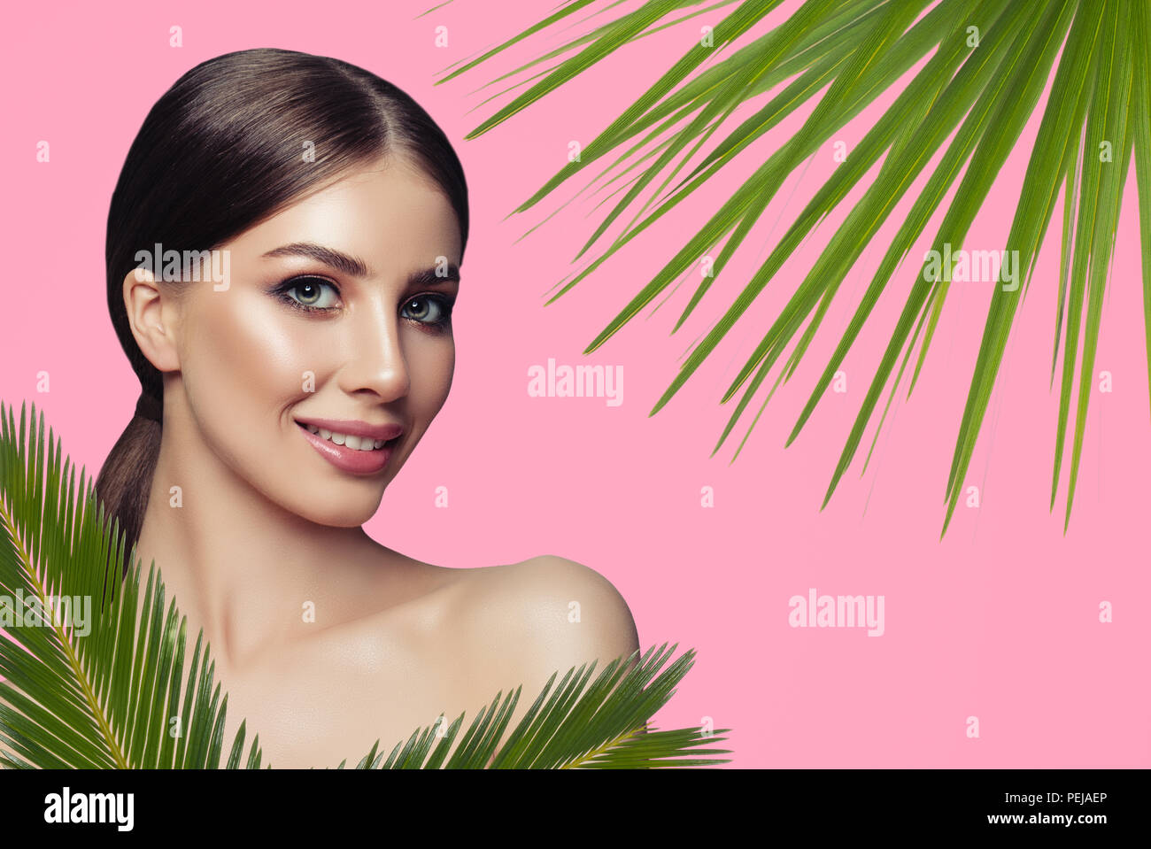 Beautiful young woman with perfect skin, cute smile and natural make up ...