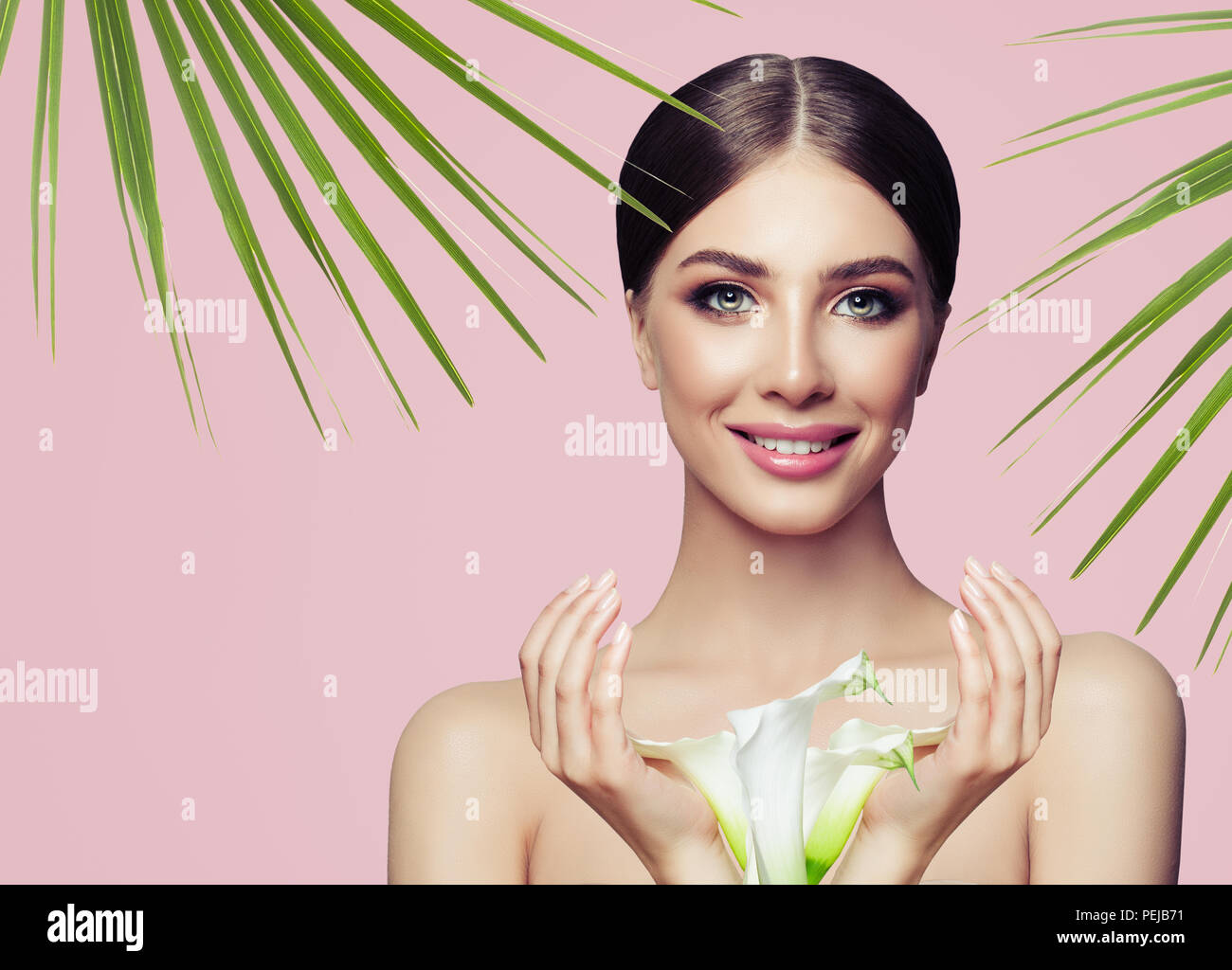 Perfect young woman smiling, spa portrait with tropic leaves and ...