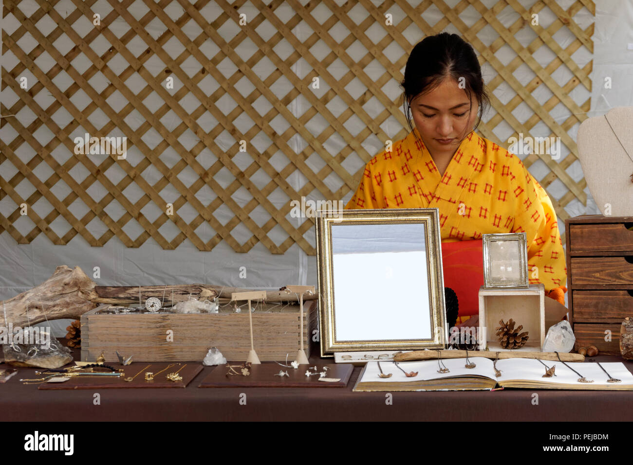 Young Japanese Canadian woman wearing a kimono selling jewelry at the ...