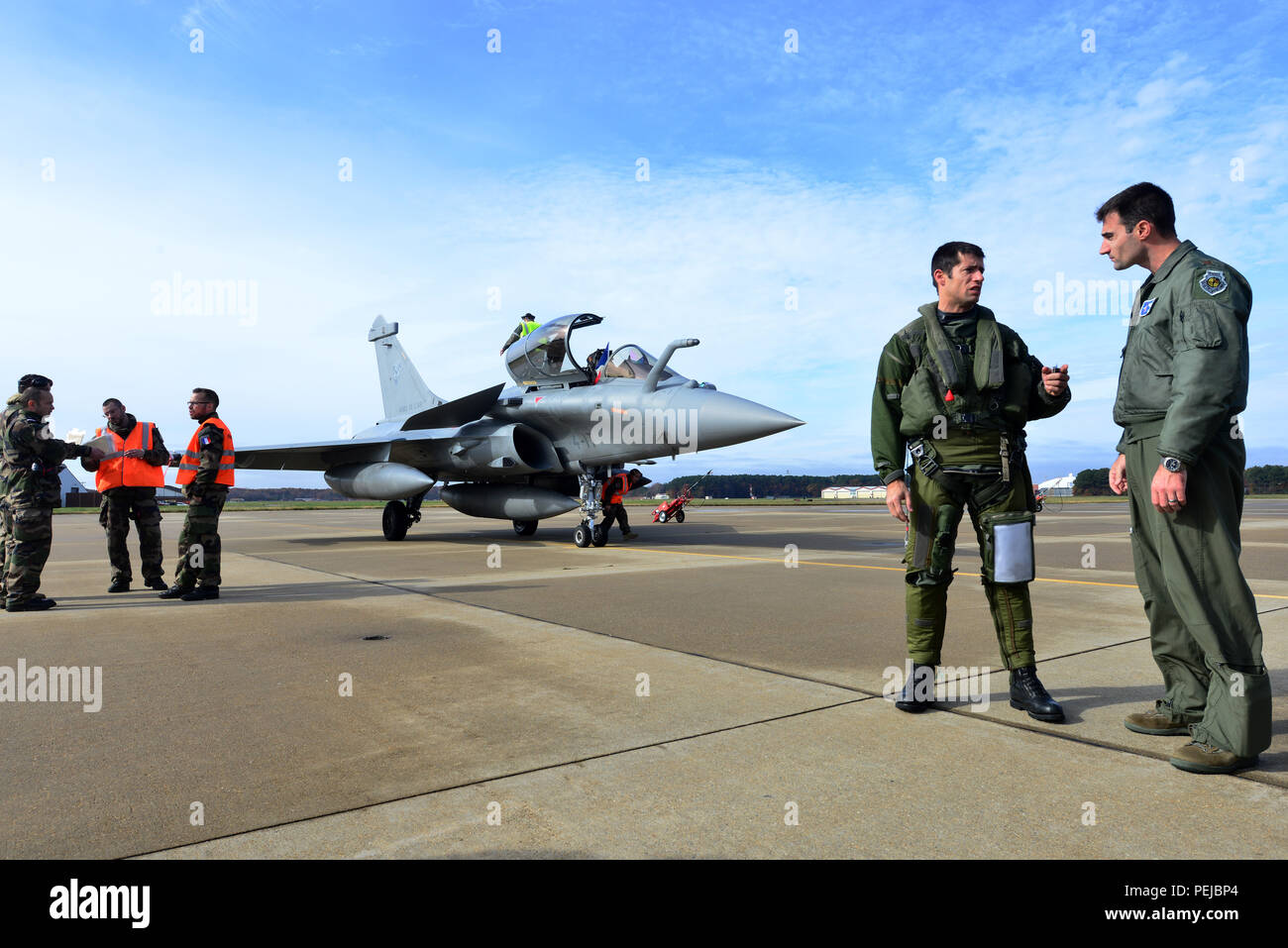 Members of the U.S. and French air forces speak before the inaugural ...