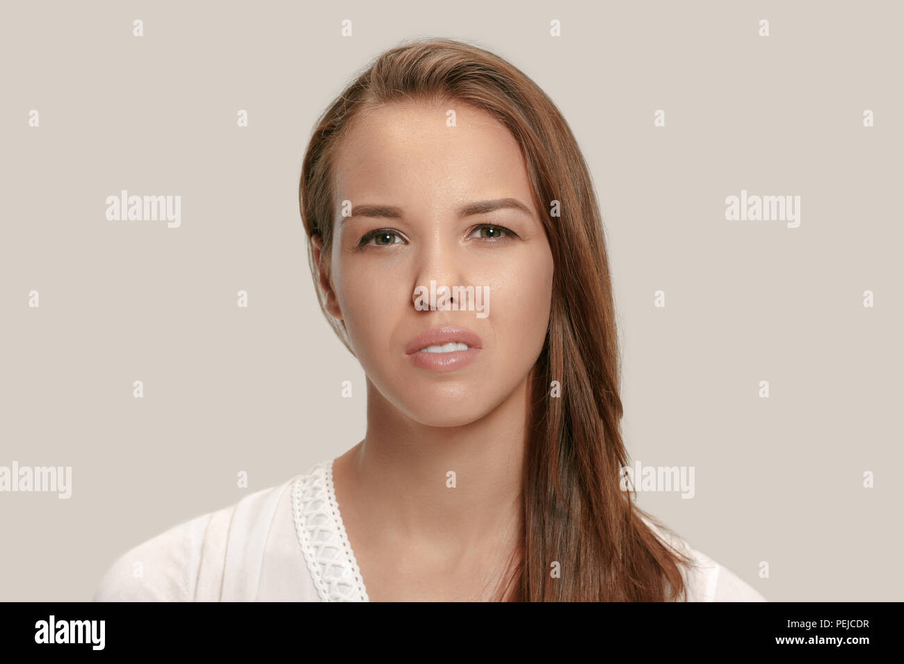 Annoyed irritated young feeling frustrated with something against white ...