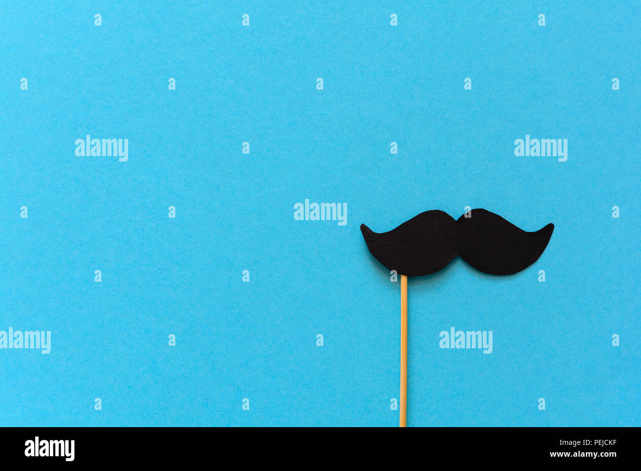 Paper moustache on booth props on blue paper background. Cut out style ...
