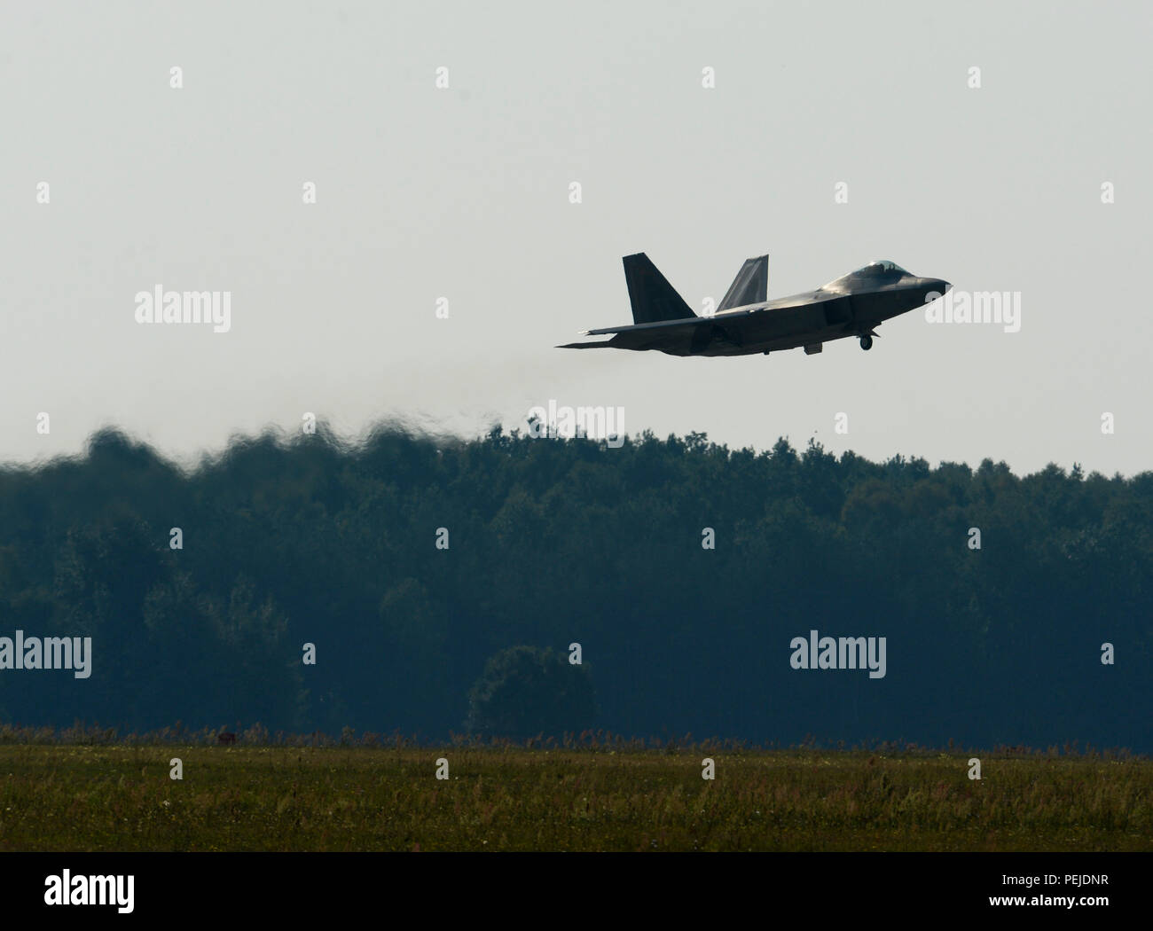 A U.S. Air Force F-22 Raptor flies over the flight line at Lask Air ...