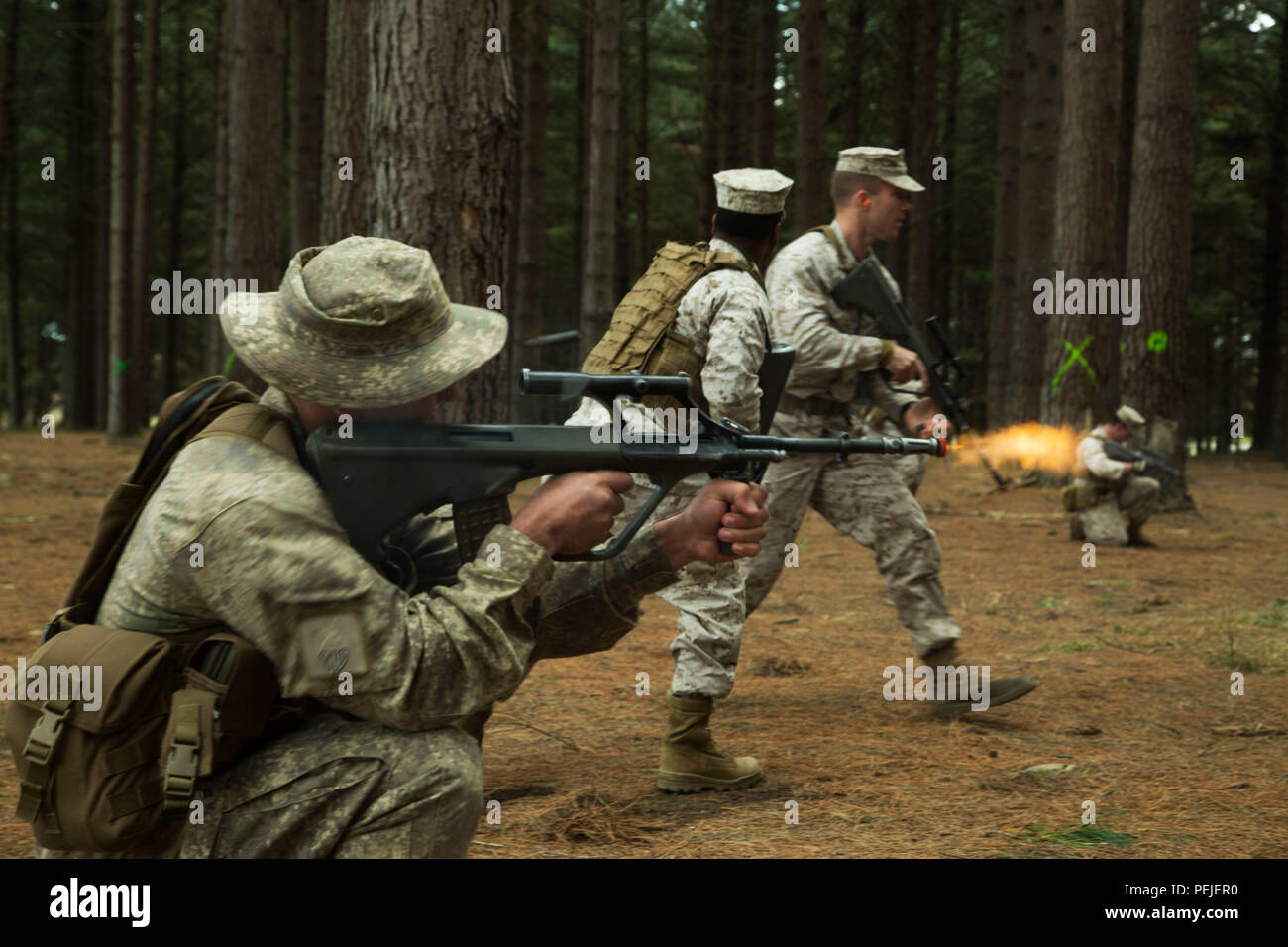 New Zealand Army Pvt. Kyash Balsara, left, fires at the simulated enemy ...