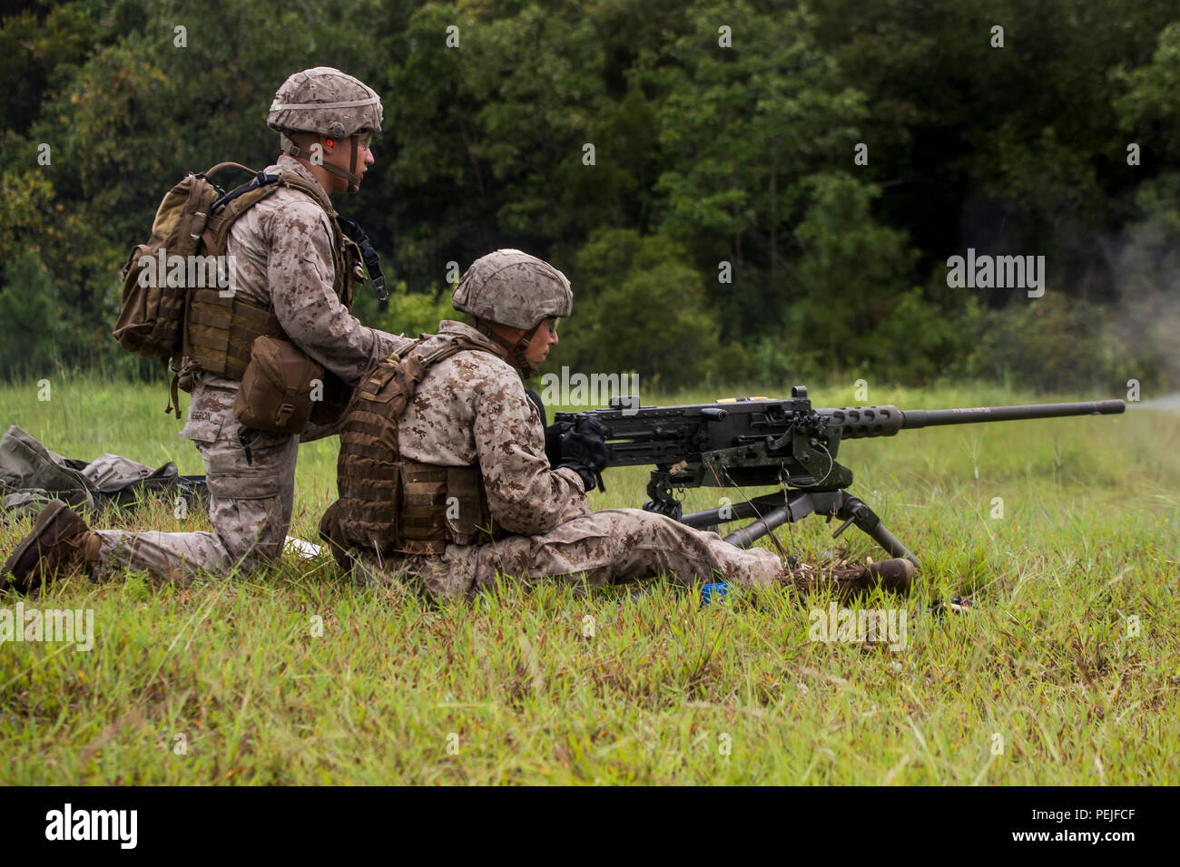 A Marine with 2nd Air Naval Gunfire Liaison Company fires the M2 .50 ...