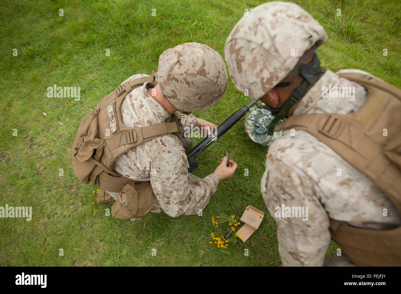 U.S. Marine Corps Cpl. Devon Howell, right, an electrician, instructs Lance Cpl. Zachary Pena, a ...