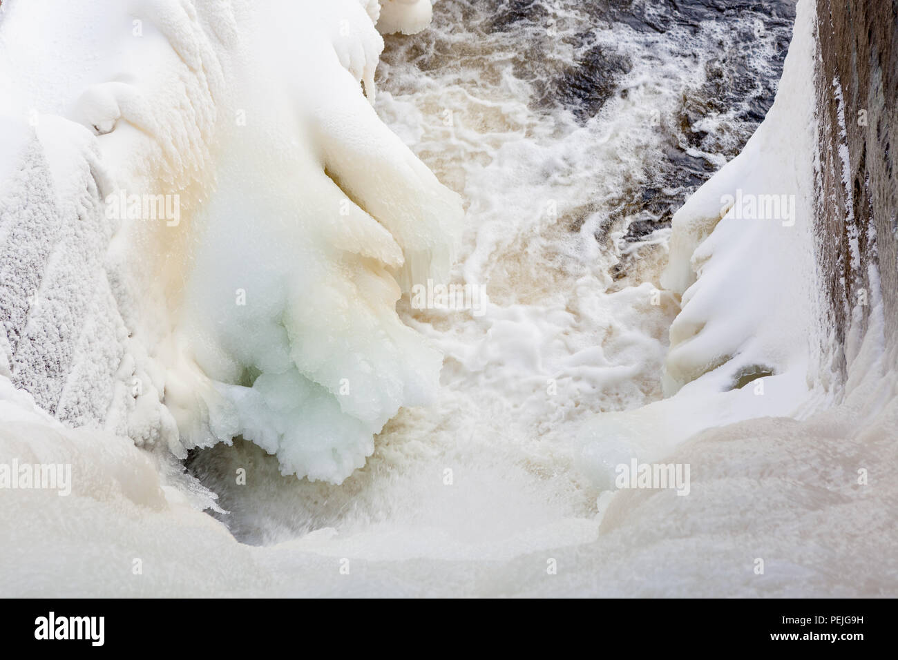 Dam at winter flowing water and ice Stock Photo - Alamy