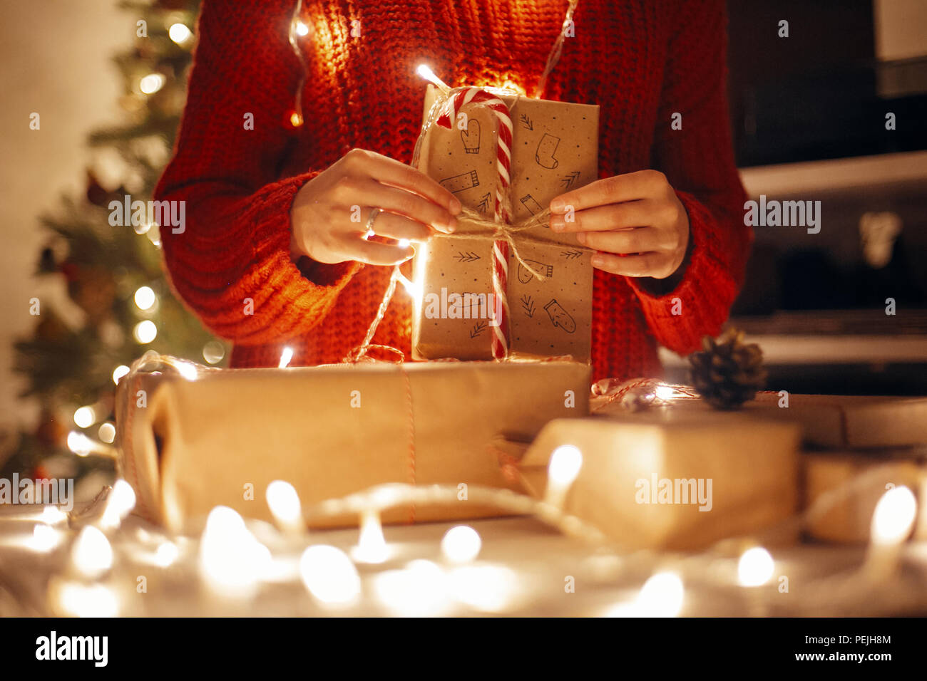 christmas magic moments. hands holding christmas present in lights in ...