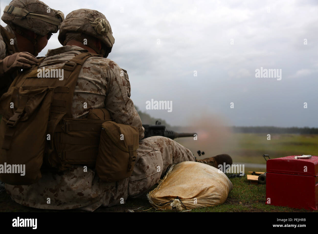 Sgt. David Sosa, left, assists Cpl. Gerardo Lopez Ortiz with firing a ...