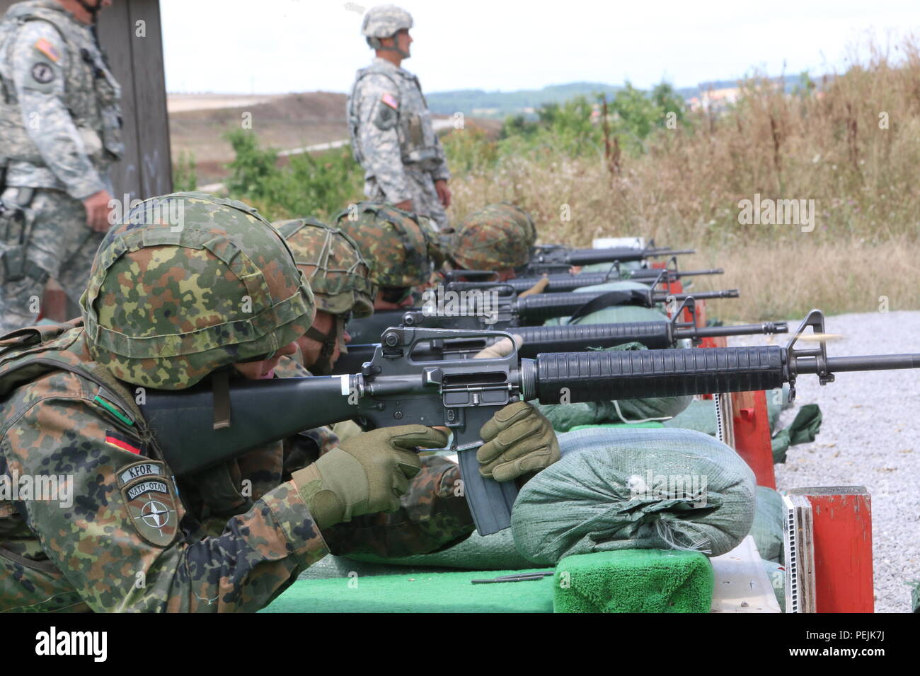 German Soldiers assigned to Multinational Battle Group-West, fire the ...