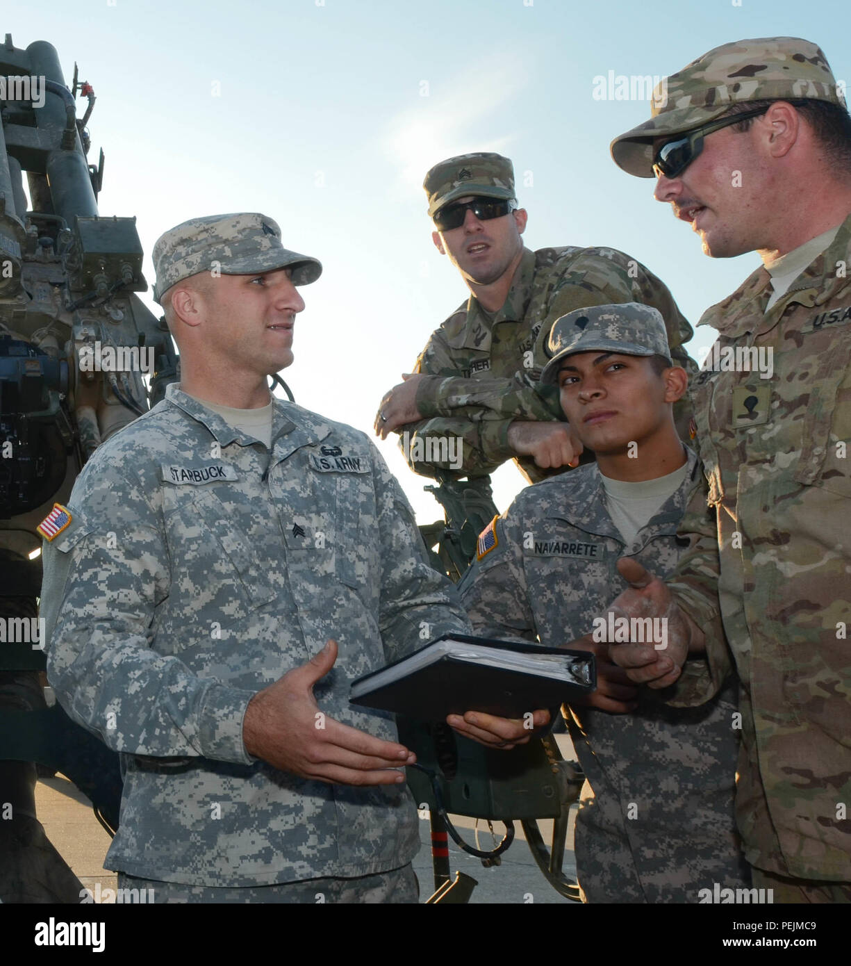 Sgt. Christopher Starbuck (left), a cannon crewmember with Battery B ...