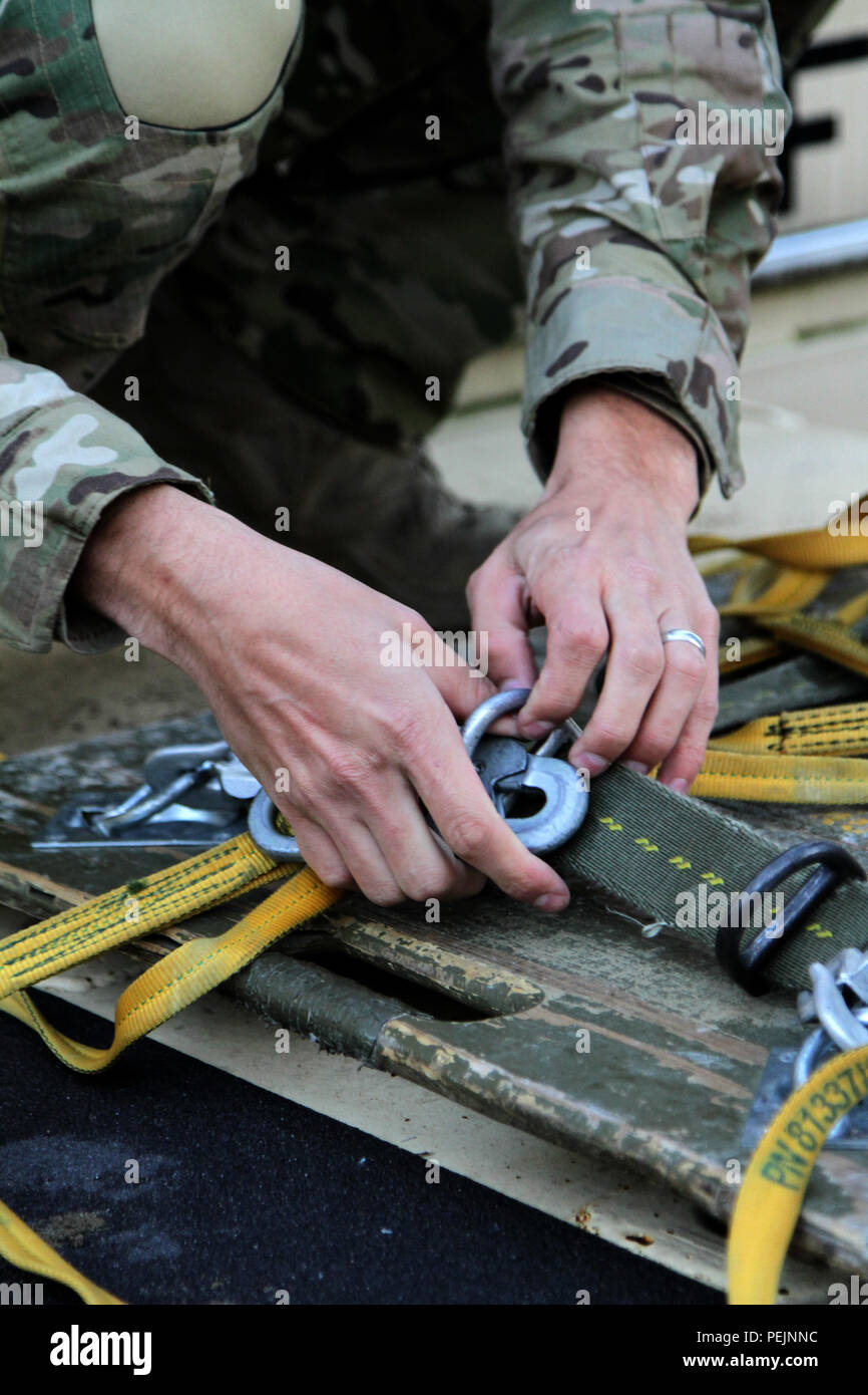 U.S. Air Force Staff Sgt. Colby Scidmore unhooks static lines to ...