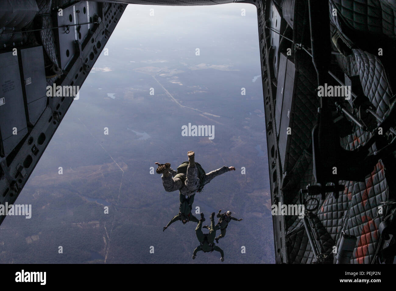 U.S. Army and Dutch jumpmasters exit a C-27 aircraft at an altitude of ...