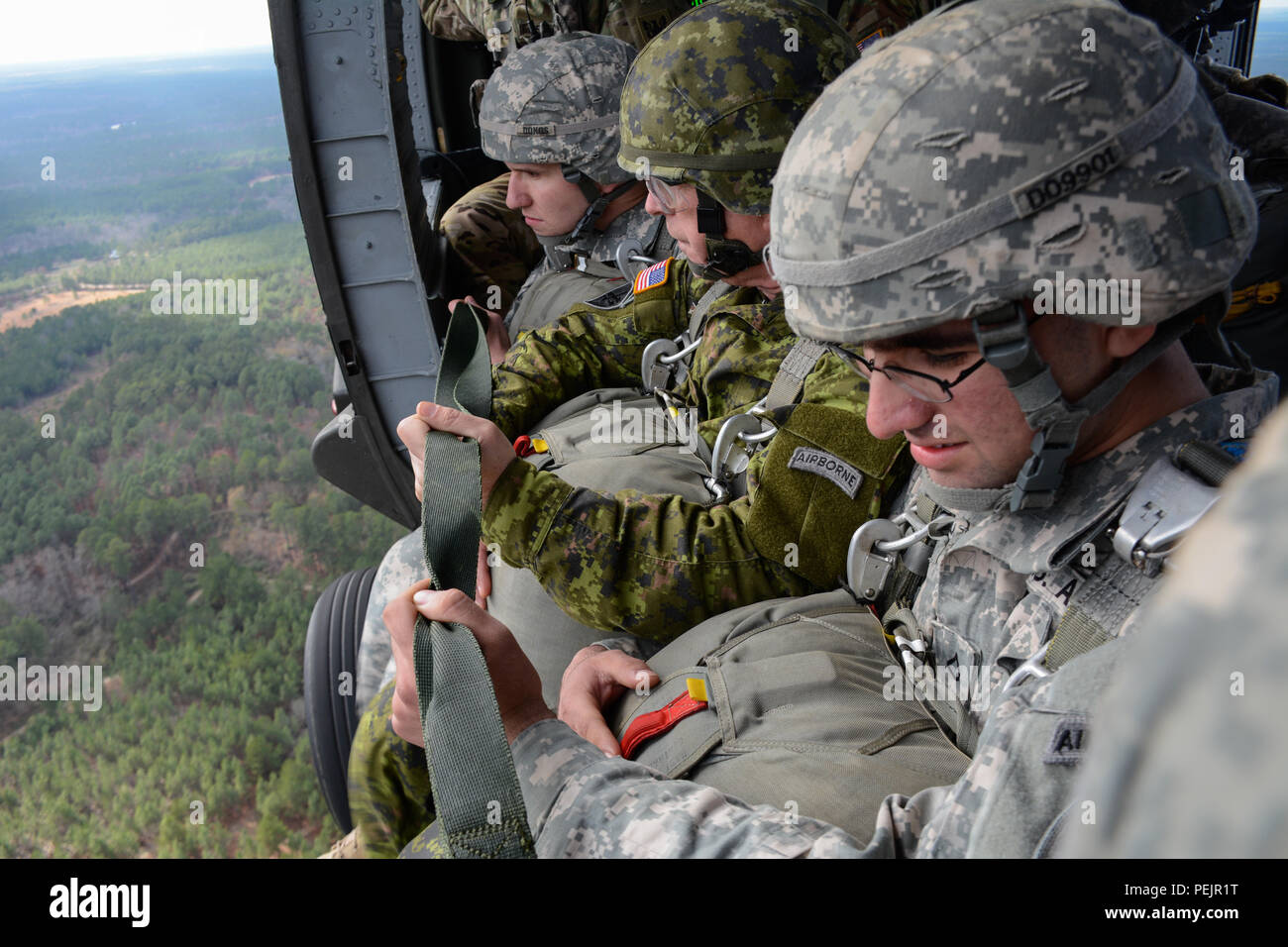 U.S. Army and Canadian airborne personnel ride in a UH-60 Black Hawk ...