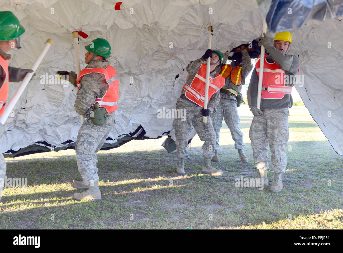 The 51st Combat Communications Squadron airmen raise a tent that will ...
