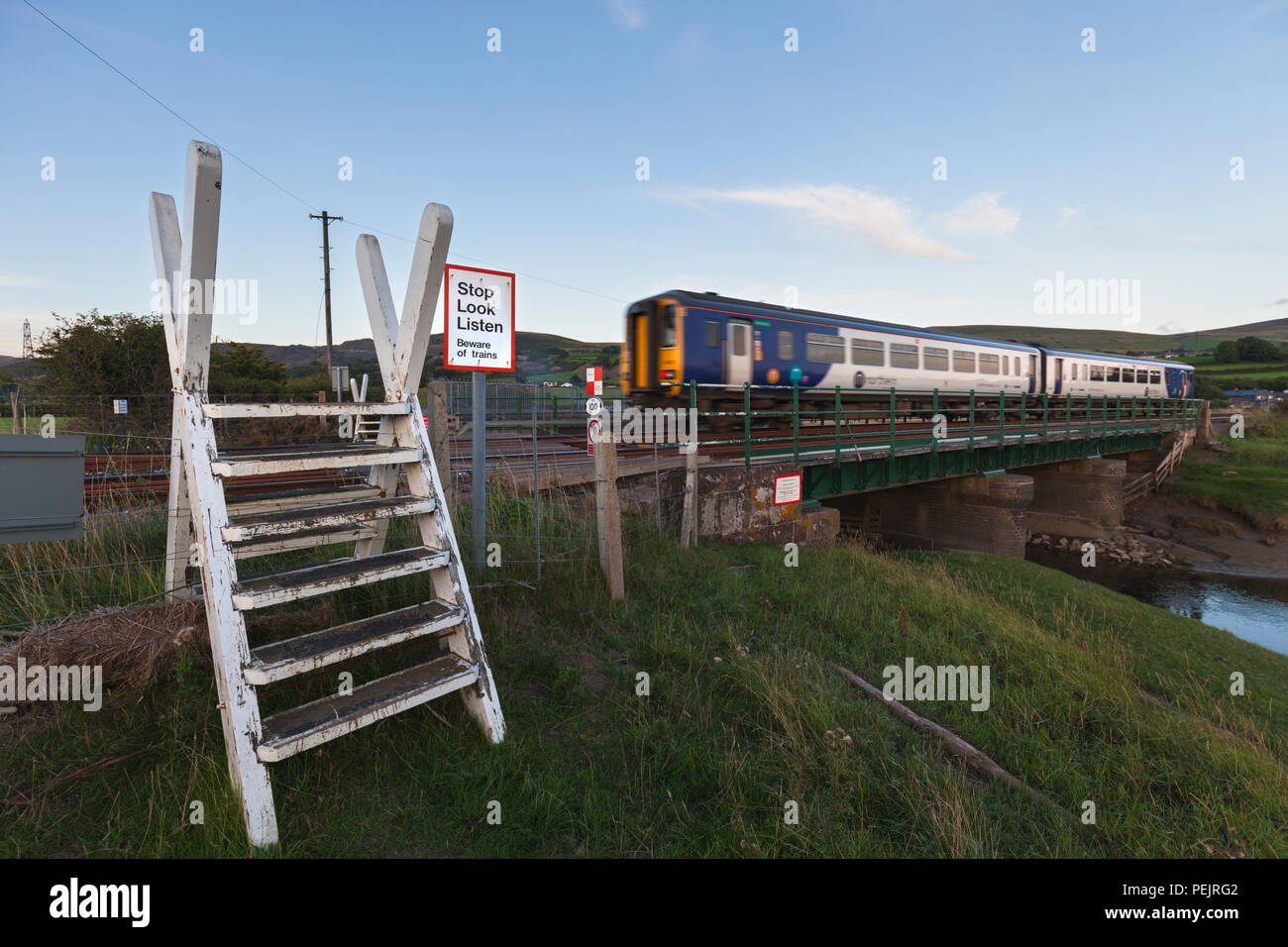 A Northern rail class 156 sprinter train passing the public foot ...