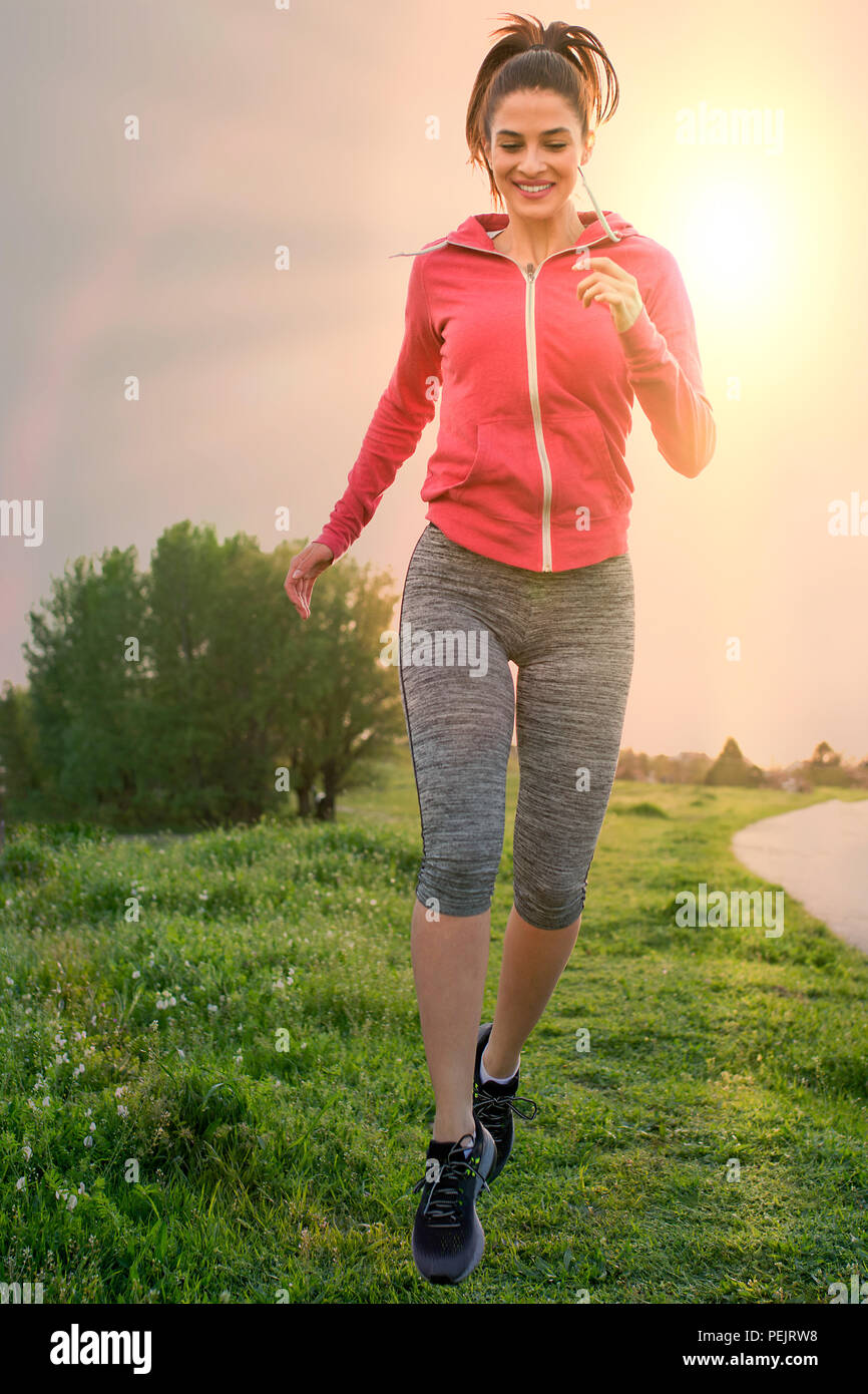 Beautiful young woman run in nature Stock Photo - Alamy