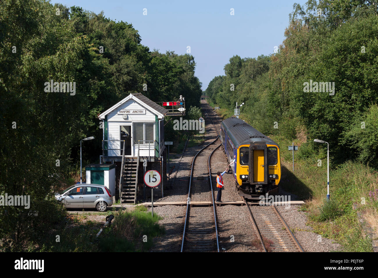 The Network Rail signaller at Rainford collects the sinle line token ...