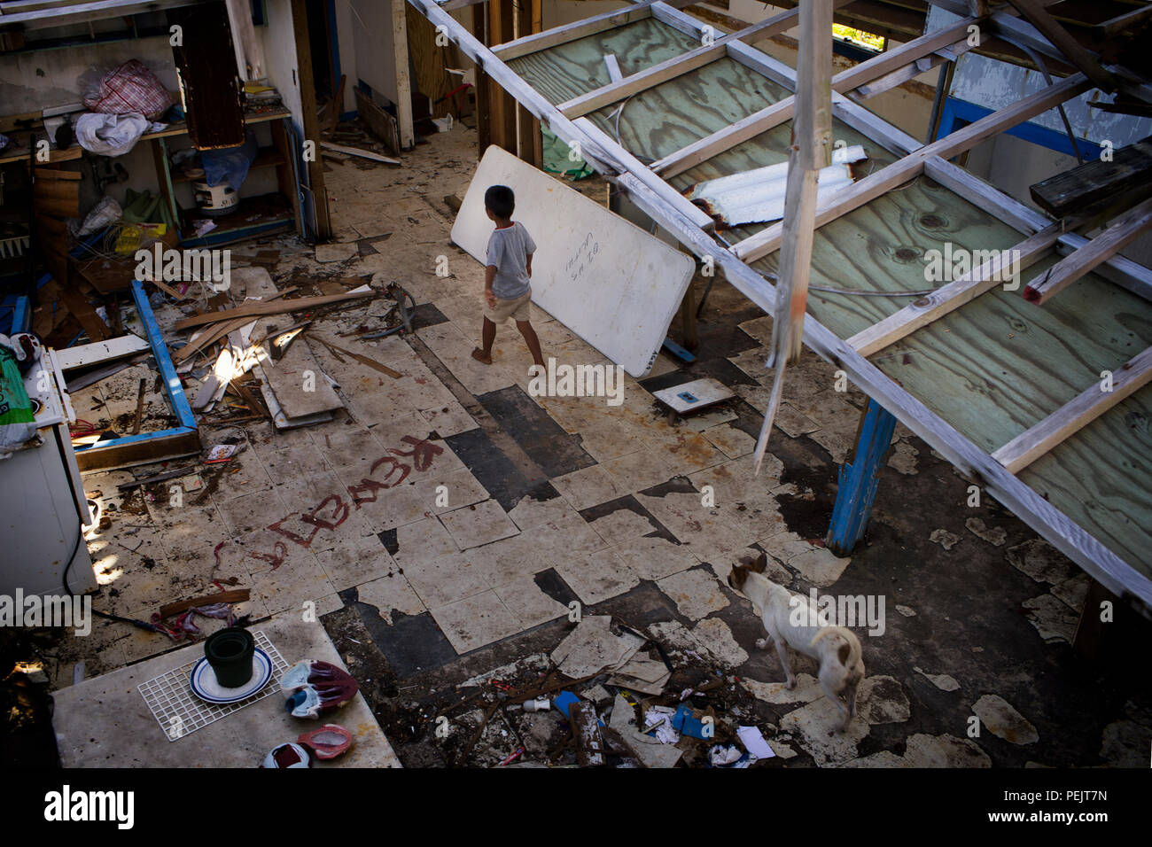 A child walks at a damaged school building at Falalop Island, Ulithi ...