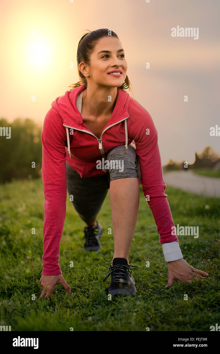 young fitness woman runner stretching legs before run Stock Photo - Alamy