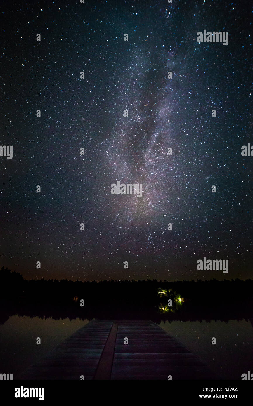 Dock on the lake at night with the Milky Way in the background Stock ...