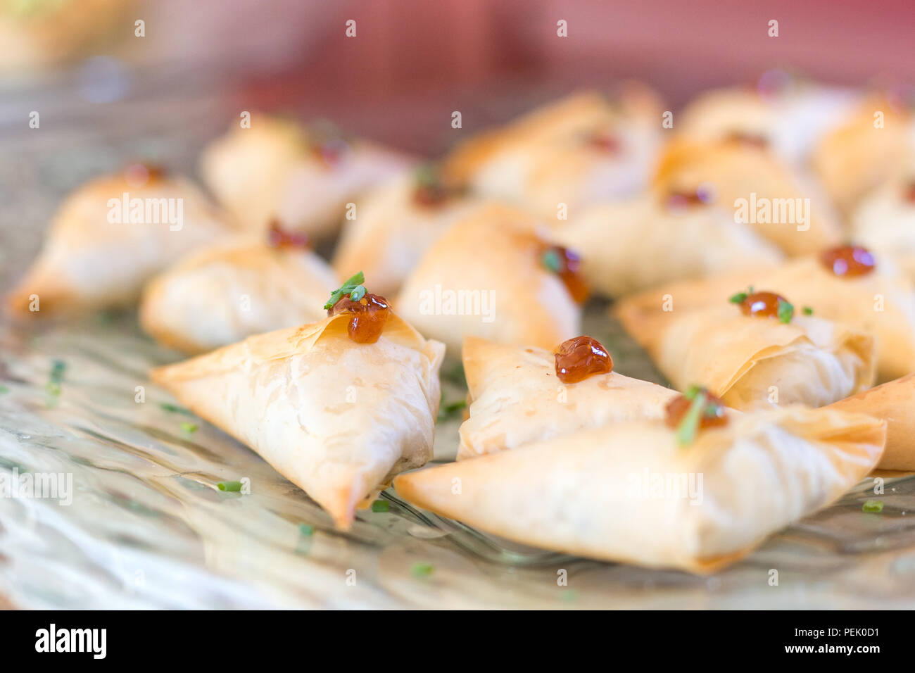 Filo pastry parcels on a glass plate Stock Photo - Alamy