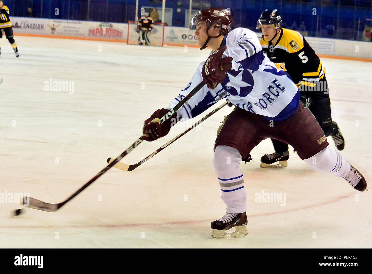 Senior Airman Brendan Elliott passes the puck against the Army's ...