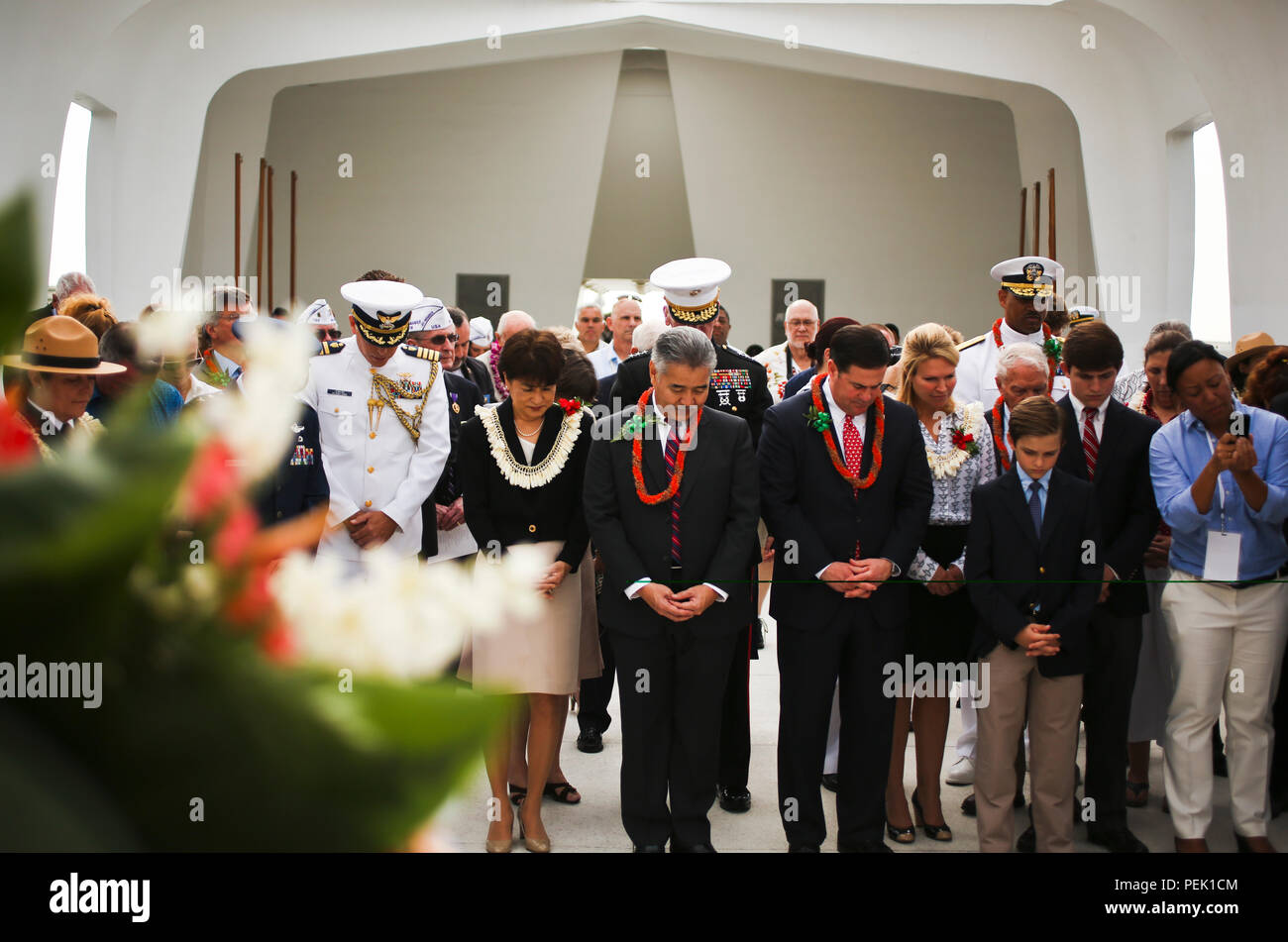 Participants attending the Pearl Harbor Day Commemoration Ceremony bow ...