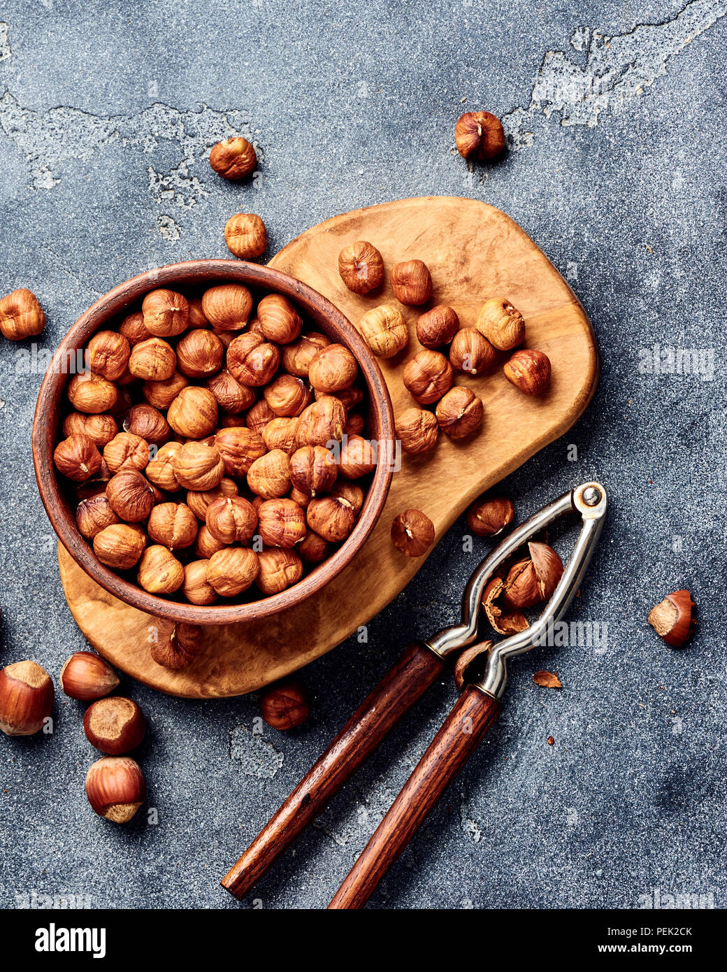 Hazelnuts with nutcracker on gray background. Top view of nuts Stock Photo - Alamy
