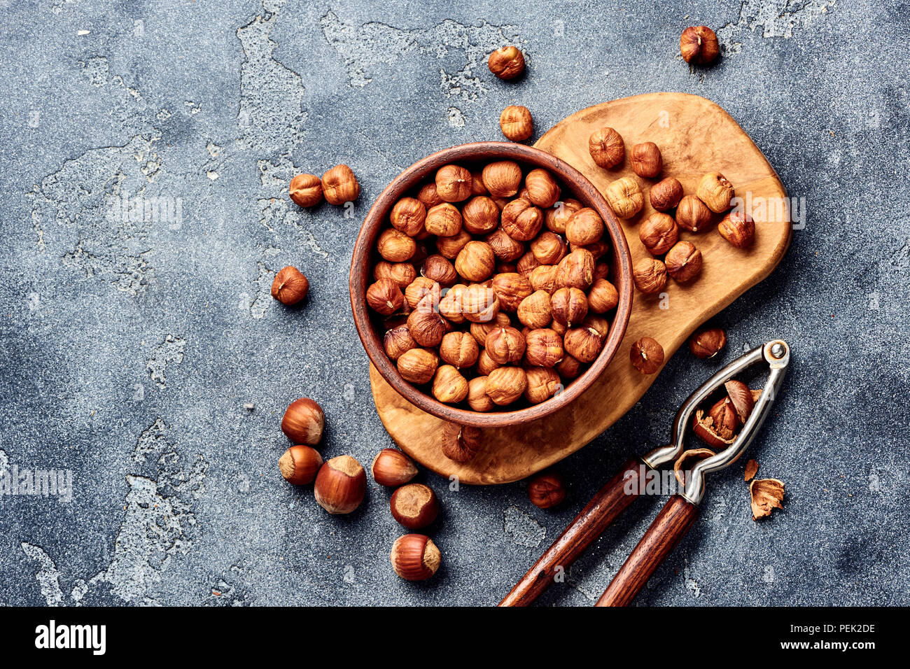 Hazelnuts with nutcracker on gray background. Top view of nuts Stock ...