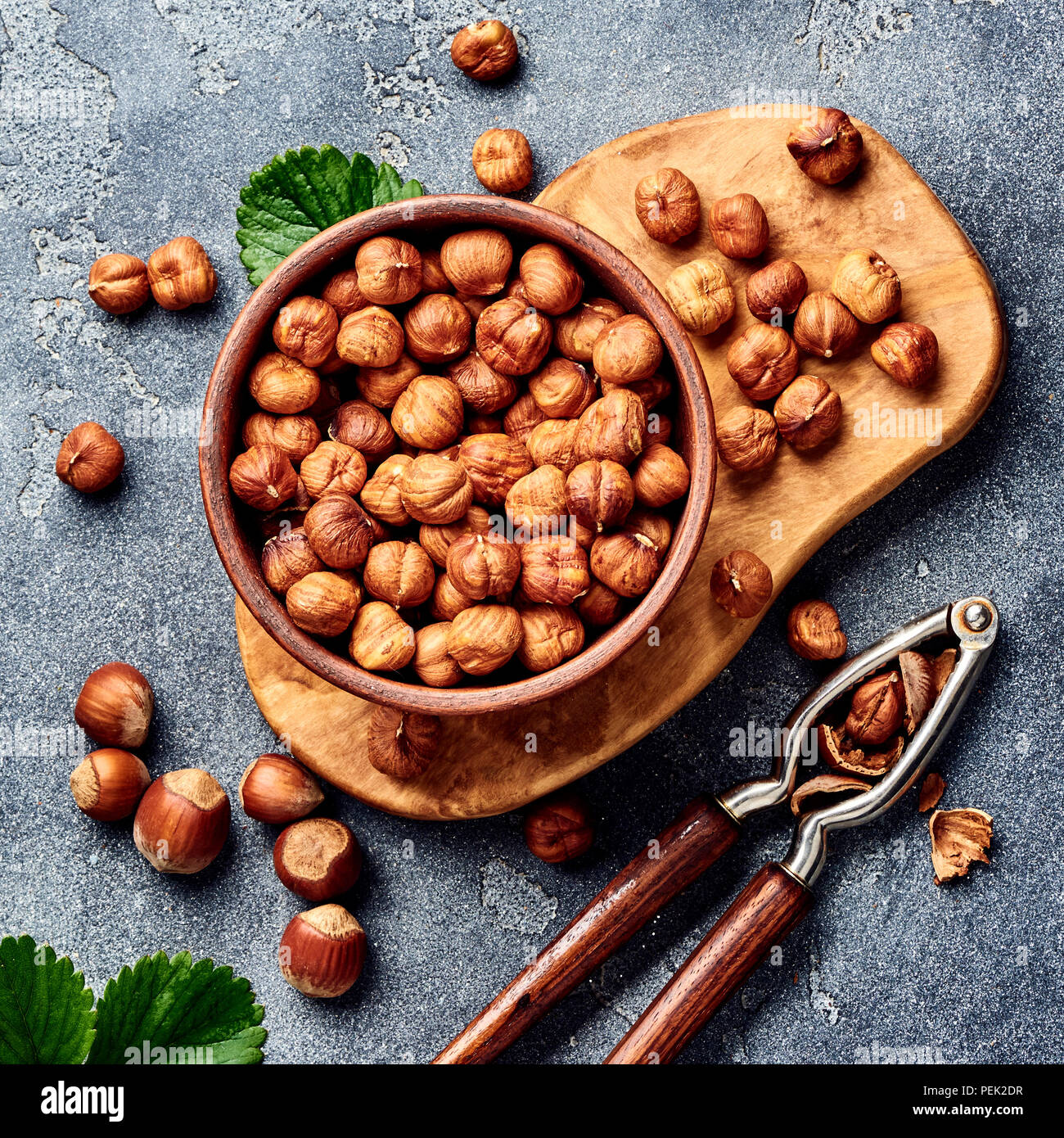 Hazelnuts with nutcracker on gray background. Top view of nuts Stock ...