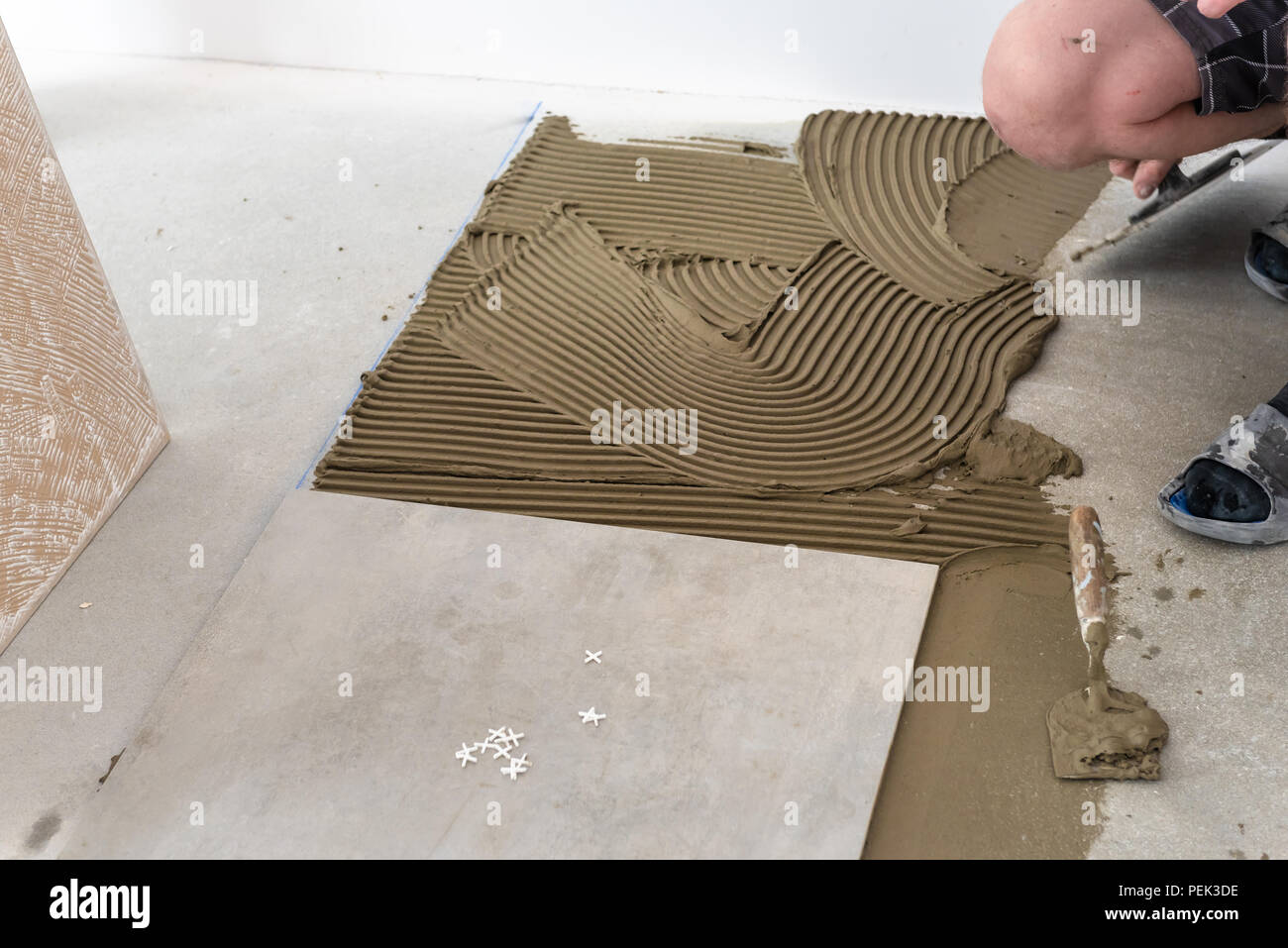 Tiling Floor. The tiler builder arranges the floor ceramics Stock Photo ...