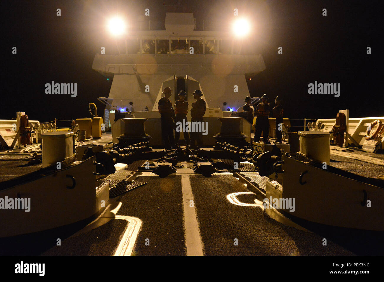 Crew members from Coast Guard Cutter Stratton stand by the anchors ...