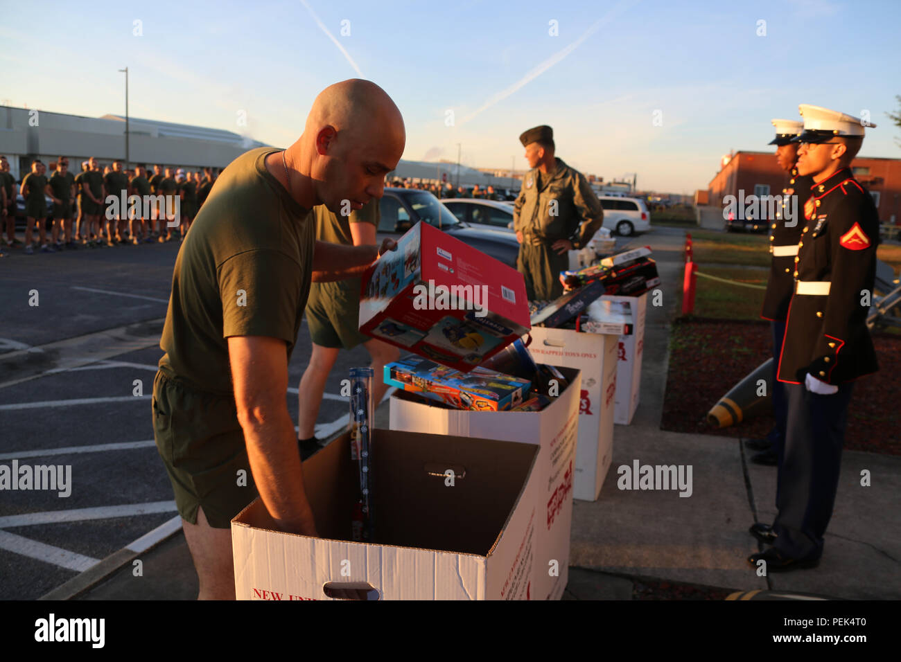 Sergeant Major Alex Narvaez places a toy in a donation box during a ...