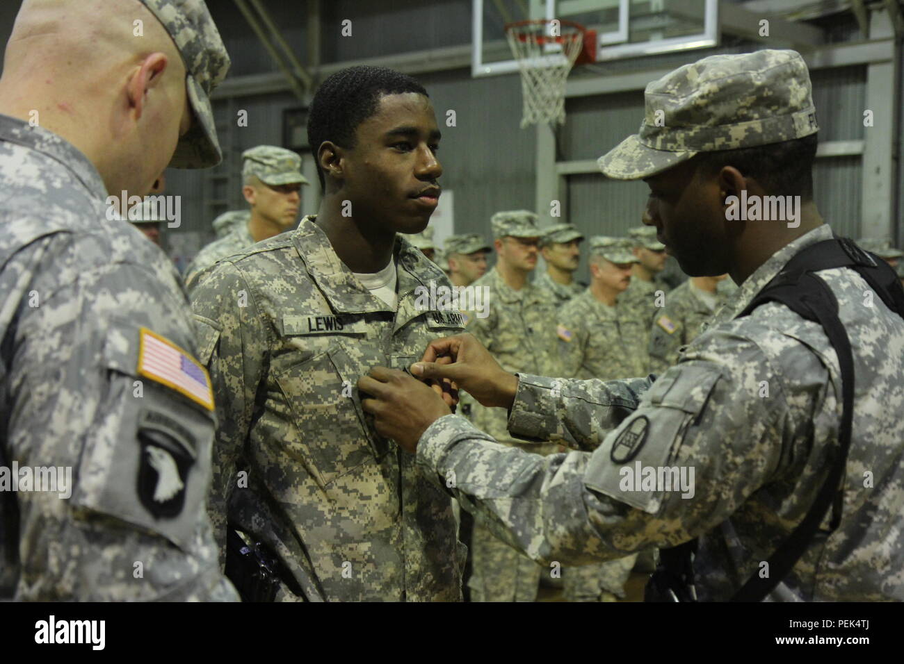 U.S. Army Staff Sgt. Anthony Fultz (right) promotes Sgt. Devin Lewis ...