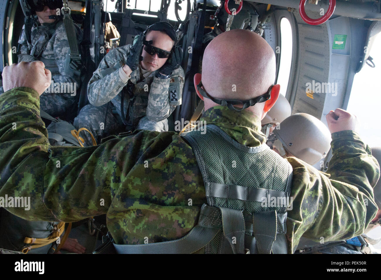 Canadian Armed Forces Sgt. Joe Hillier, a jumpmaster, conducts an ...