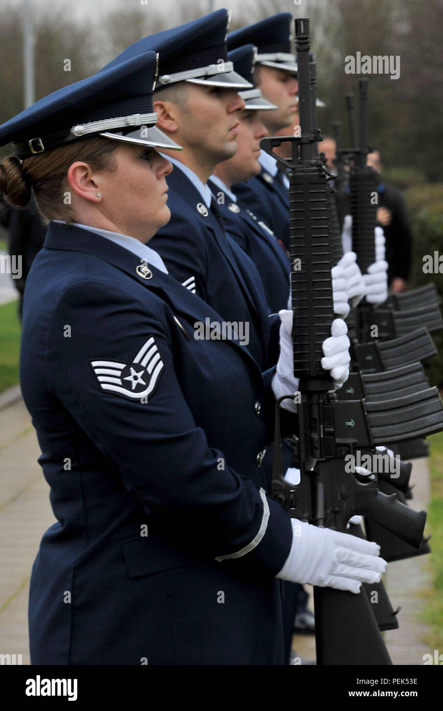 The 423rd Air Base Group Honor Guard salute while Taps is played during ...
