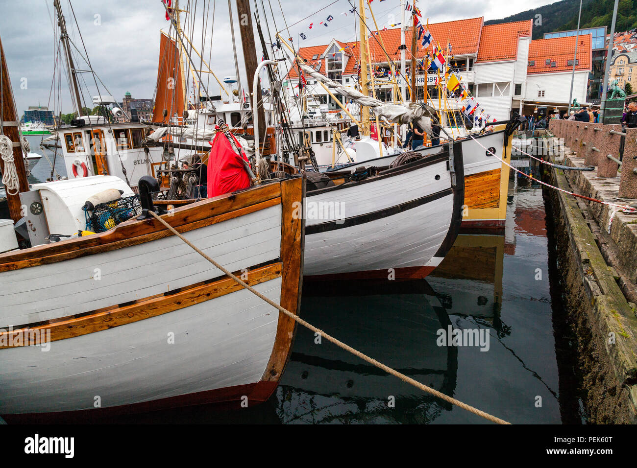 Veteran fishing vessels lined up in the inner port of Bergen, Norway ...
