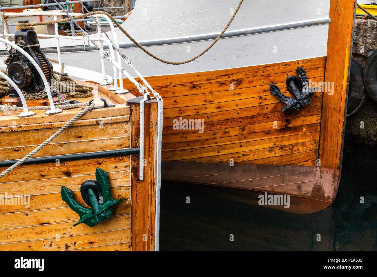 The bows and anchors of two veteran fishing boats in the port of Bergen ...