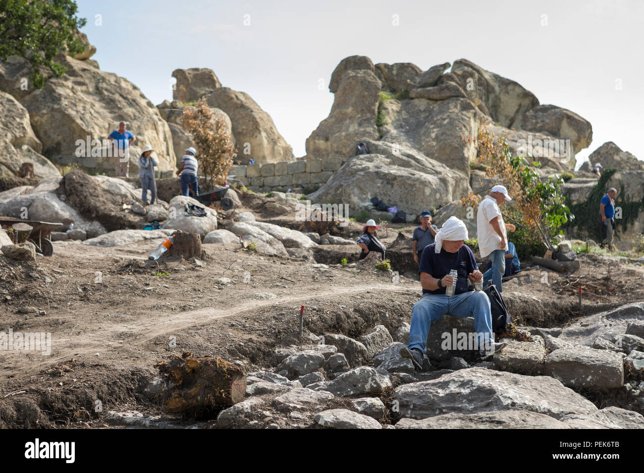 Workers digging at ancient excavation site with Thracian and Greek ...