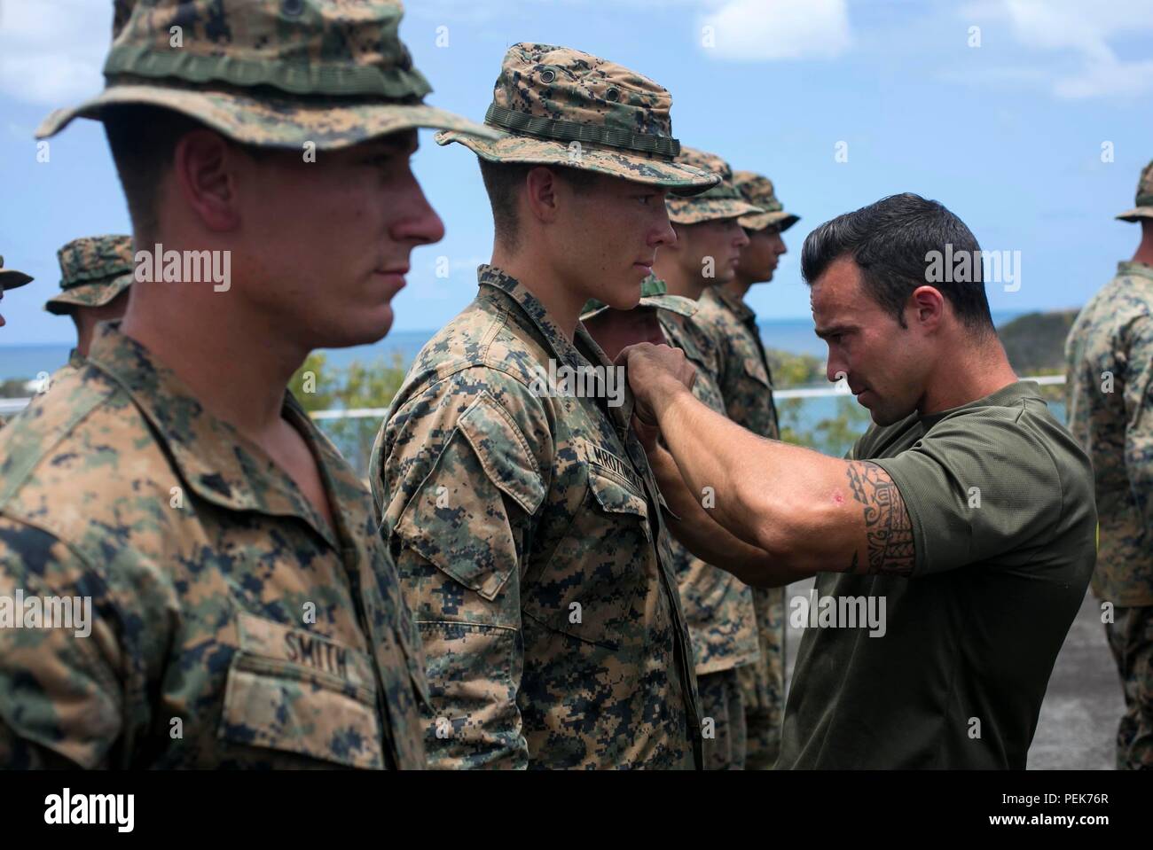 U.S. Marines with 1st Battalion, 2nd Marine Regiment, receive the ...