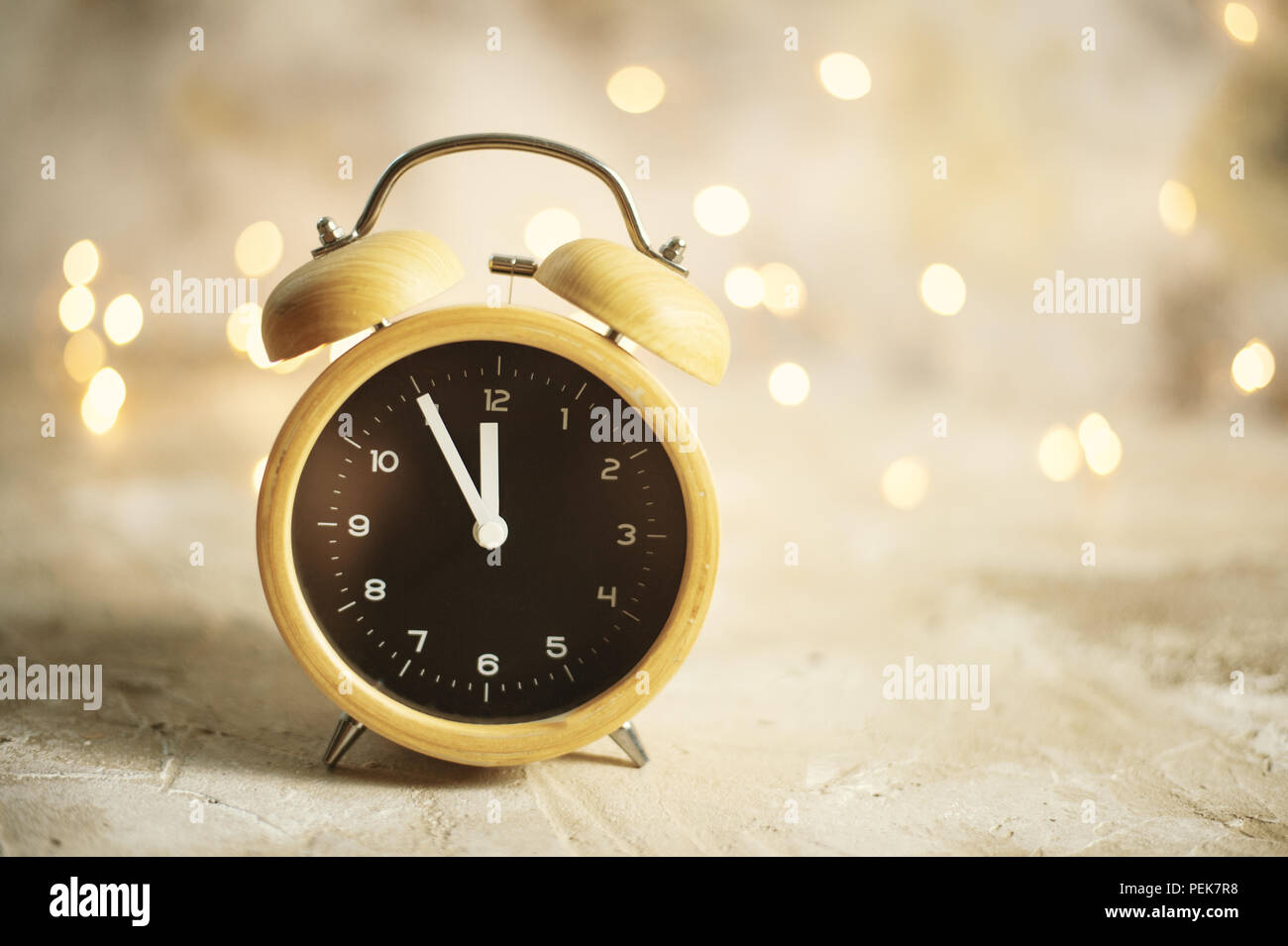 vintage alarm clock is showing midnight. It is twelve o'clock ...