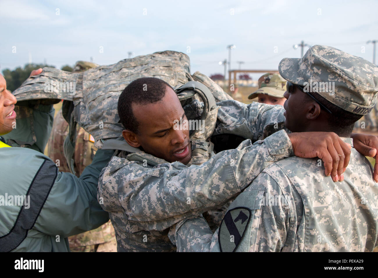 Sgt. Justyn Duke (center), a geospatial engineer with Headquarters and ...