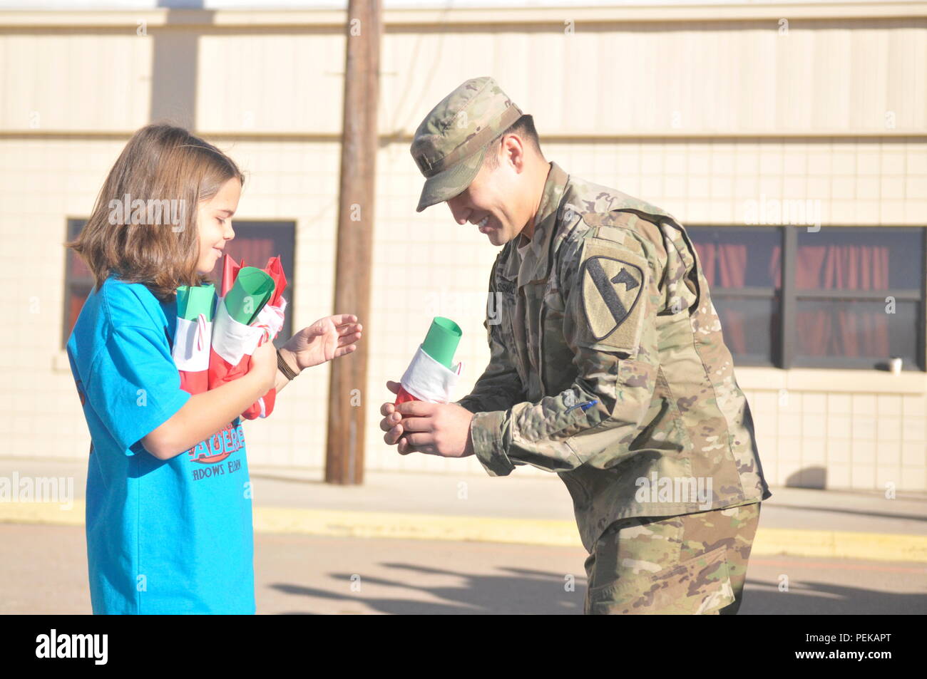 A Meadows Elementary School student gives a holiday stocking to a Soldier with the 2nd Battalion ...