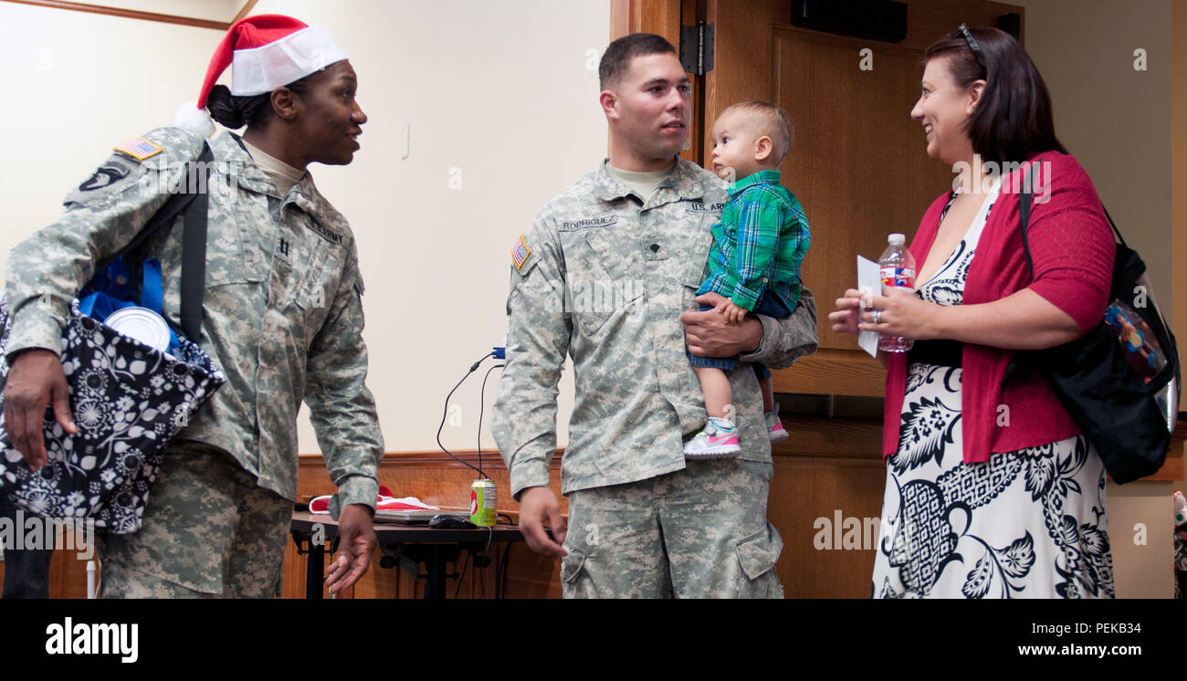 An Army captain helps a family with their Holiday Meal kit during ...